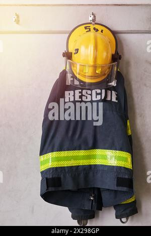 Firefighter coat hanging on fire truck Stock Photo - Alamy