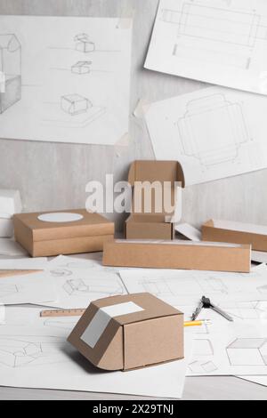 Creating packaging design. Drawings, boxes and stationery on light ...