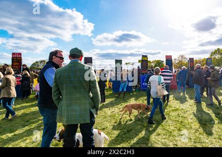 Crowds gather around the Bookmaker Stands in the field to place bets on ...