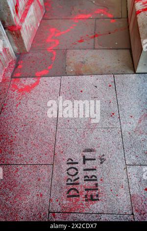 Activists from Palestine Action let off a coloured flare as they lie in ...