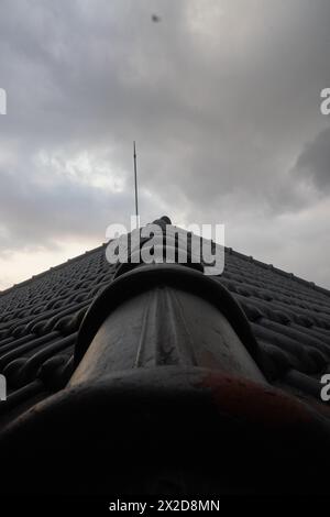 A lightning rod mounted on a roof with a cloudy sky background Stock ...