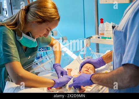 Team of doctors and nurses attending to a baby, Neonatal pediatrics ...
