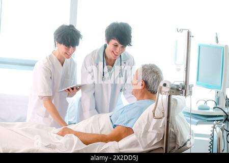 Patient in hospital room attended by a doctor, Hospital Stock Photo - Alamy