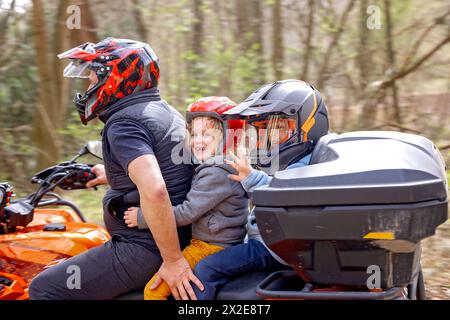 Children, riding on a buggy wheel with father, fast cars, wearing ...