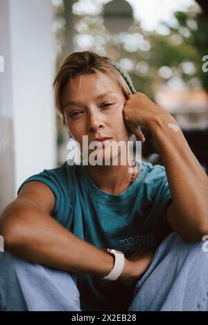 portrait of a young woman without make up and with long hair on a white ...