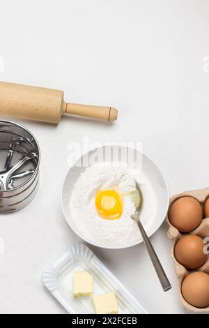 Bowl plate with flour and egg yolk on white background..Top view Stock ...