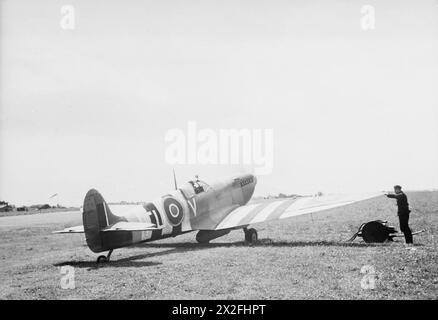 A long range fuel tank of a spitfire, converted to hold beer, is being ...