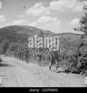 British Eighth Army infantry men run through the dust of the Western ...