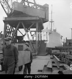 Inside a Tyneside shipyard in 1943, a woman marks rivet holes on metal ...
