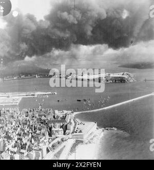 Official photograph - Smoke and flame from oil tanks in St. Malo ...