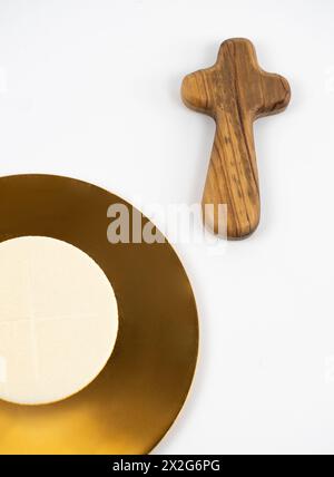 Gilded paten with white altar bread - holy bread, white background ...