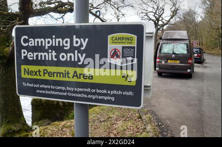 CAMPING BY PERMIT ONLY SIGN WITH CAMPERVANS AT LOCH VENACHAR IN THE ...