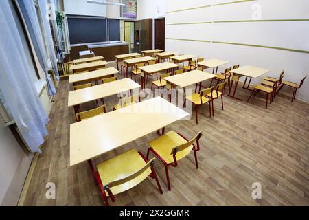 Back view of chairs in physics school class; blackboard with formula ...