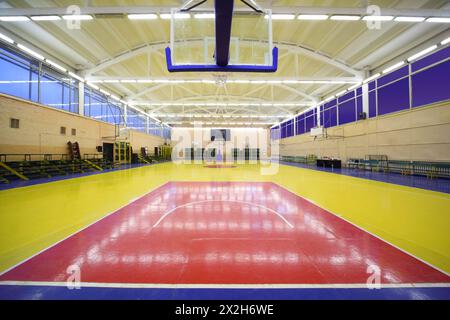 Inside lighted school gym hall with red-yellow floor and basket Stock ...