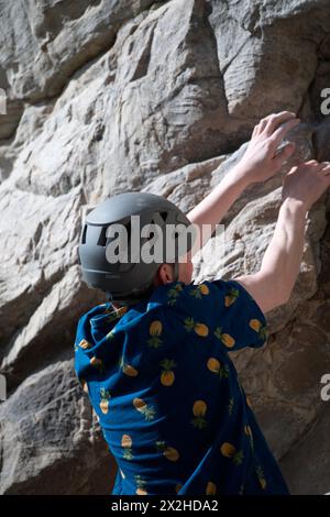 Back of climber gripping rock Stock Photo - Alamy