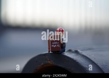Lego minifigure Peter Parker sitting and reading a book with blurred ...