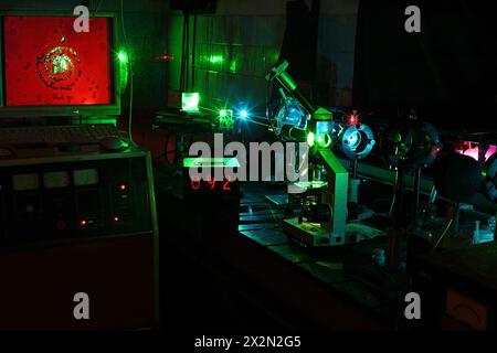Movement of microparticles by laser in dark lab with timer, monitor ...