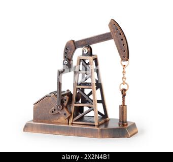 Metal mechanical miniature model of oil derrick isolated on white ...