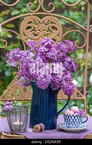 Vase with lilac flowers on chair near color wall Stock Photo - Alamy