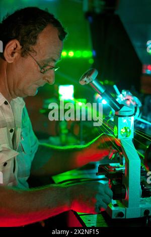 Scientist engaged in research in his lab about movement of ...