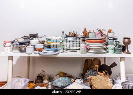 Kitchen clutter, utensils and kitchenware on a table. Concept of ...
