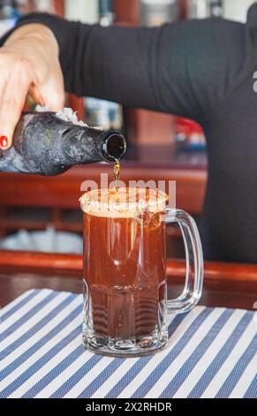 Preparing to taste a delicious bloody mary Stock Photo - Alamy