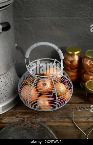 Raw onions in a wire basket Stock Photo - Alamy