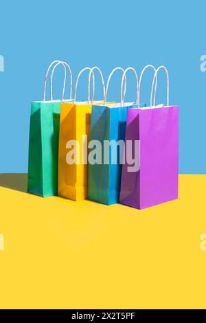 Colourful paper shopping bags against gradient background Stock Photo ...