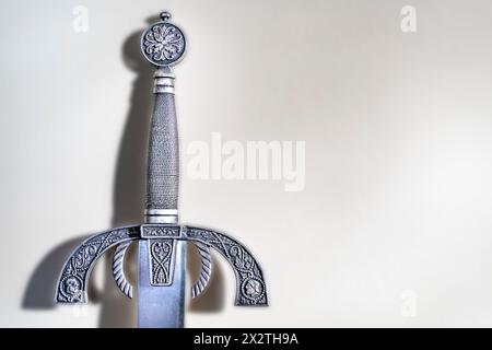 Ornate metal sword hilt with light background Stock Photo - Alamy