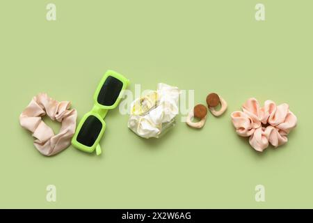 Perfume bottle, sunglasses and silk scrunchy on wooden background Stock ...