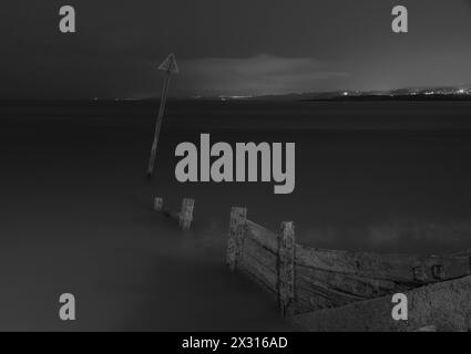 Triangular sea marker at the end of a decaying a groyne, Exmouth Devon ...