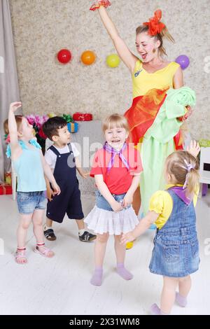 Five little kids and holiday representative draw at children party ...