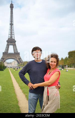 A woman stand a front Eiffel Tower at the Trocadero place in Paris ...