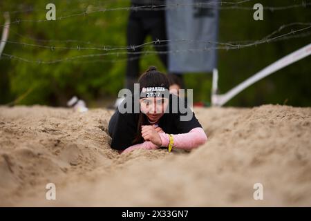Young Ukrainian women crawling in sand under barbed wire during the ...
