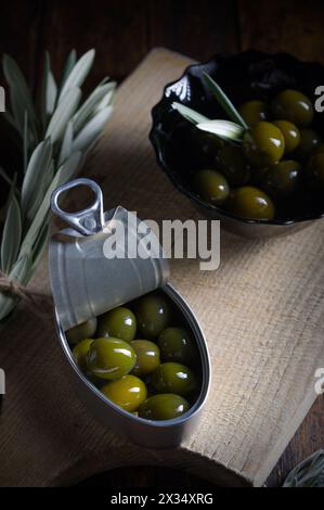 Olives in isolated containers with rustic bottom Stock Photo - Alamy