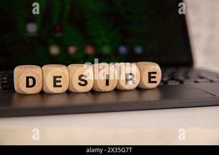 Desire symbol. Concept word Desire on wooden cubes. Beautiful yellow ...