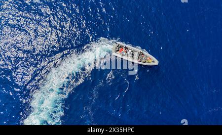 Sailors operate a 11-meter rigid-hulled inflatable boat (RHIB) during ...