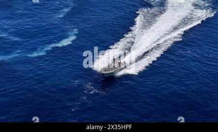 Sailors operate a 11-meter rigid-hulled inflatable boat (RHIB) during ...