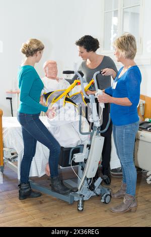 nurses with mannequin training to use hoist Stock Photo - Alamy