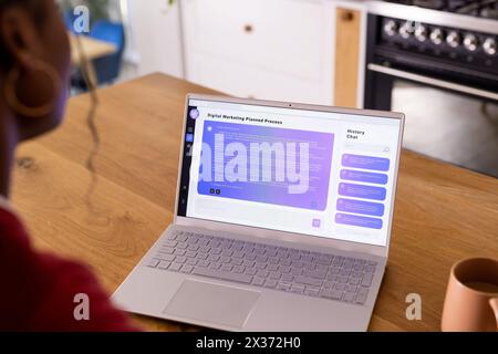 Woman using a chatbot on her laptop Stock Photo - Alamy