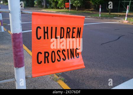 Children crossing road sign flag Stock Photo - Alamy