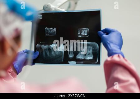Dentist looks X-ray for diagnosis Stock Photo - Alamy
