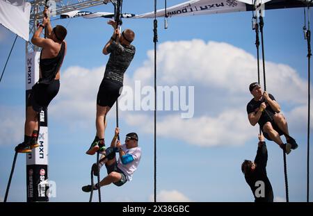 Athletes climbing the ropes at the Spartan Race competition in Kyiv ...