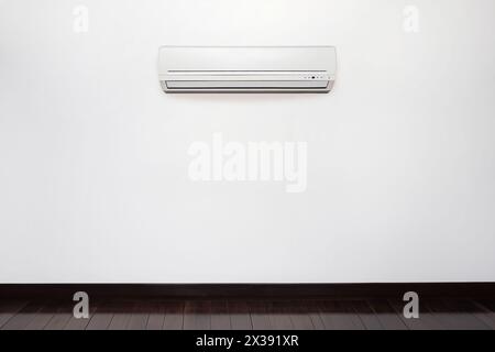 Modern wall-mounted air conditioner installed in a room, providing ...