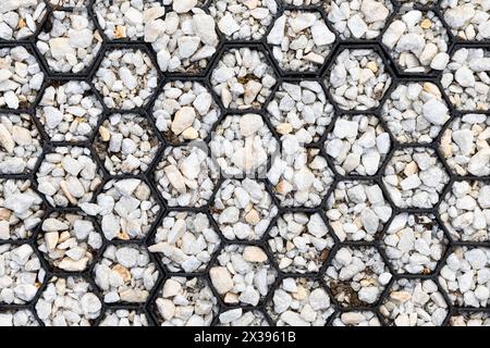 geogrid filled with small stones in the garden. geogrid filled with ...