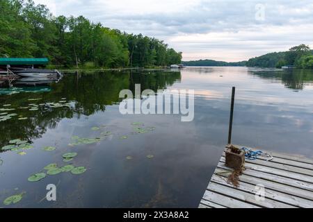 Looking off the corner of a pier on a Wisconsin Lake during dusk. Taken ...