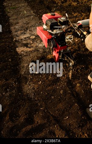 a tillerblock plows the land in the garden. A tillerblock for plowing ...