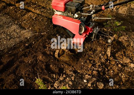 a tillerblock plows the land in the garden. A tillerblock for plowing ...