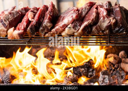 grilling steaks on flaming grill and shot with selective focus Stock ...