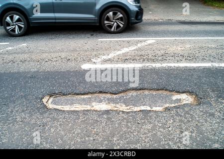 Iver Heath, Buckinghamshire, UK. 21st April, 2024. Potholes on a failed ...